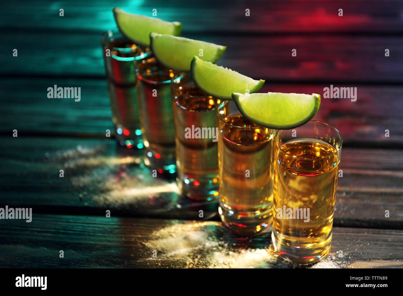 Gold tequila shots with lime and salt in bar Stock Photo - Alamy