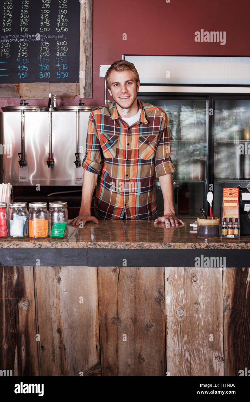 Young man standing counter coffee shop hi-res stock photography and ...
