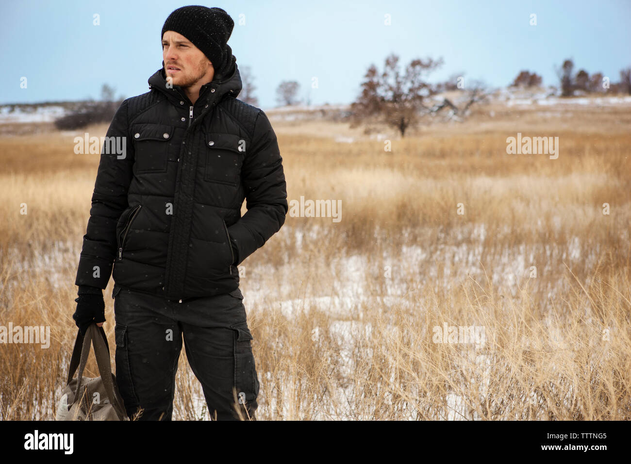 Standing man holding coat hi-res stock photography and images - Alamy