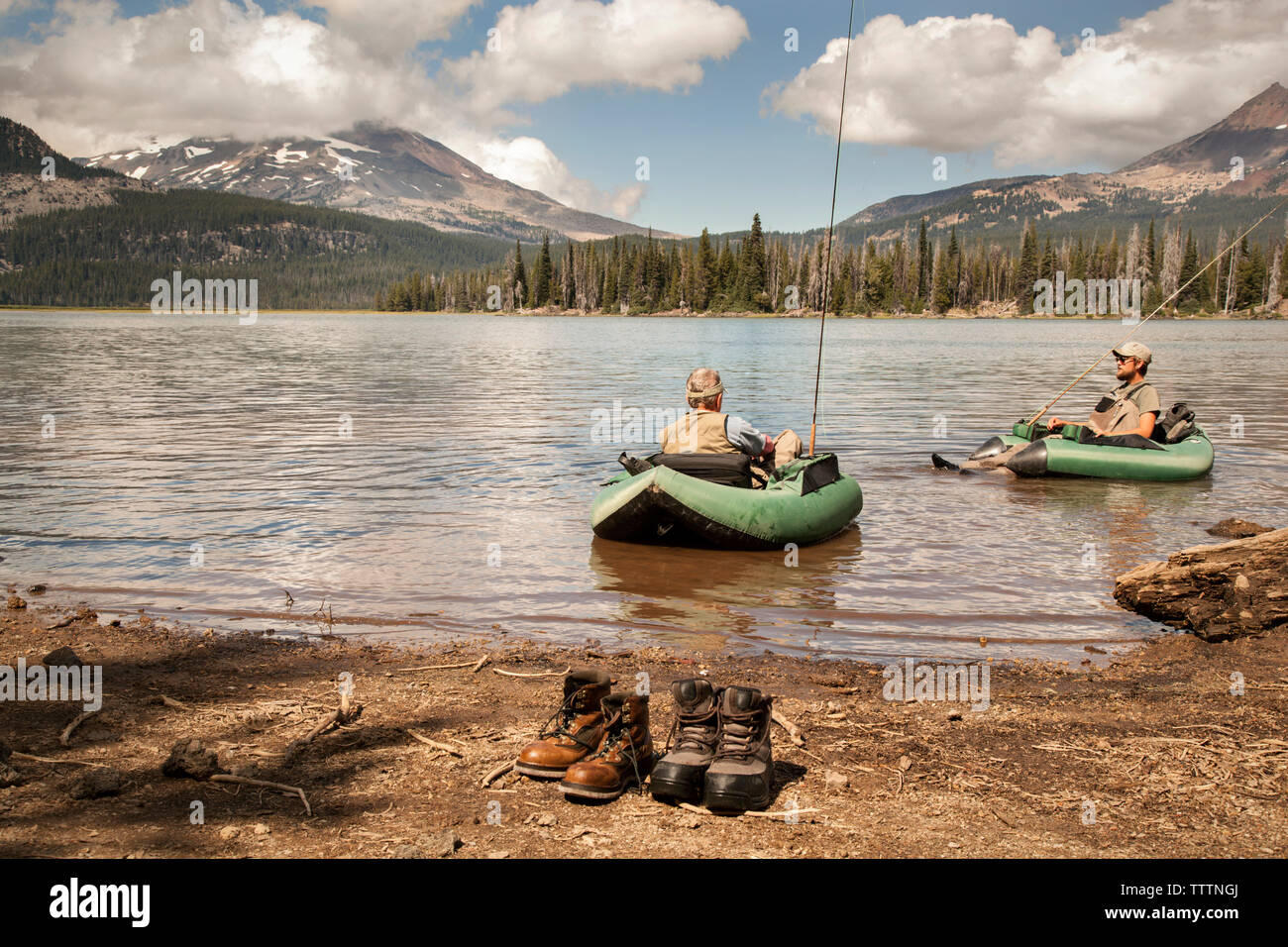Men rafting on lake against mountains Stock Photo - Alamy