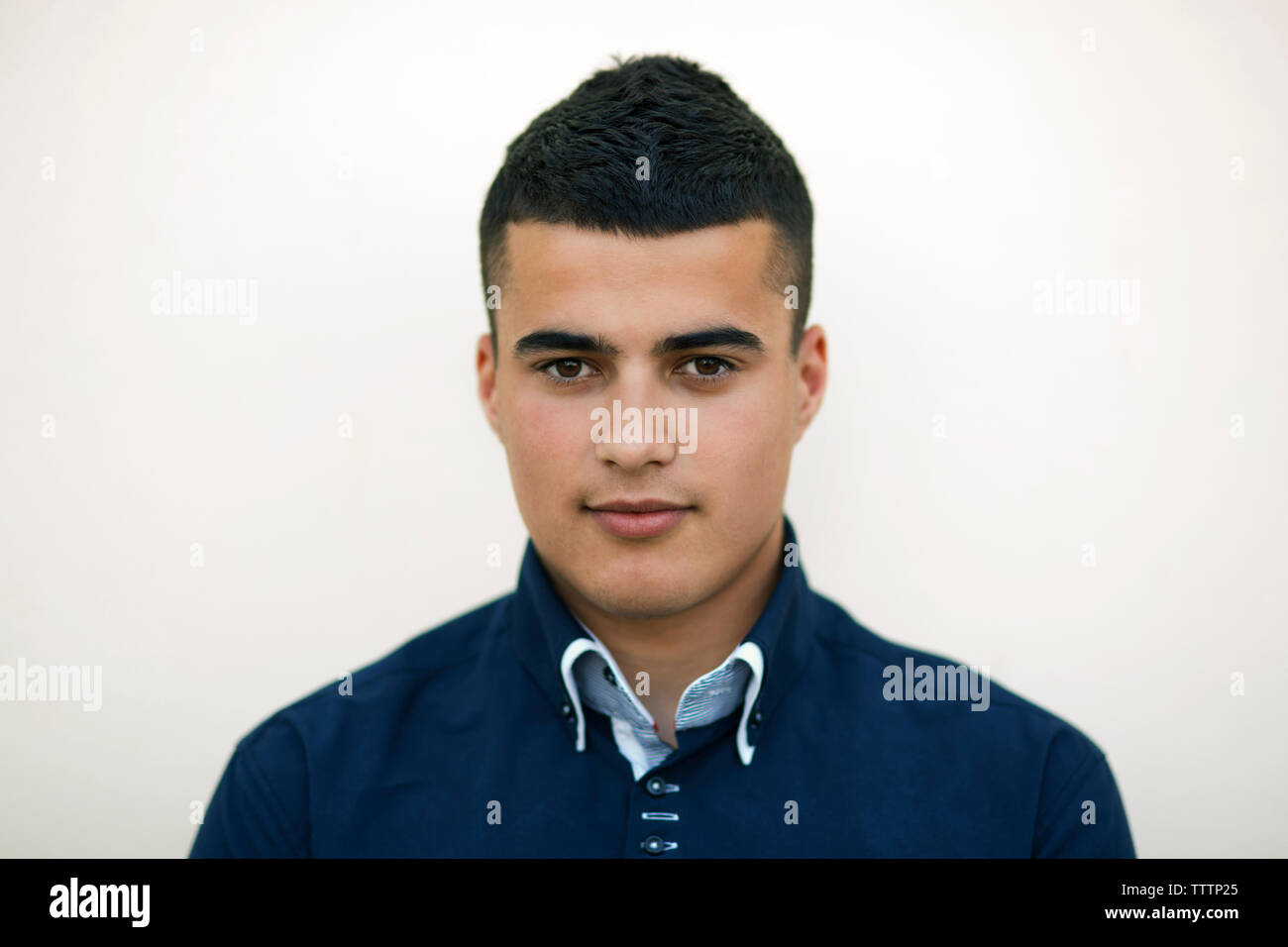 Portrait of man standing against white background Stock Photo - Alamy