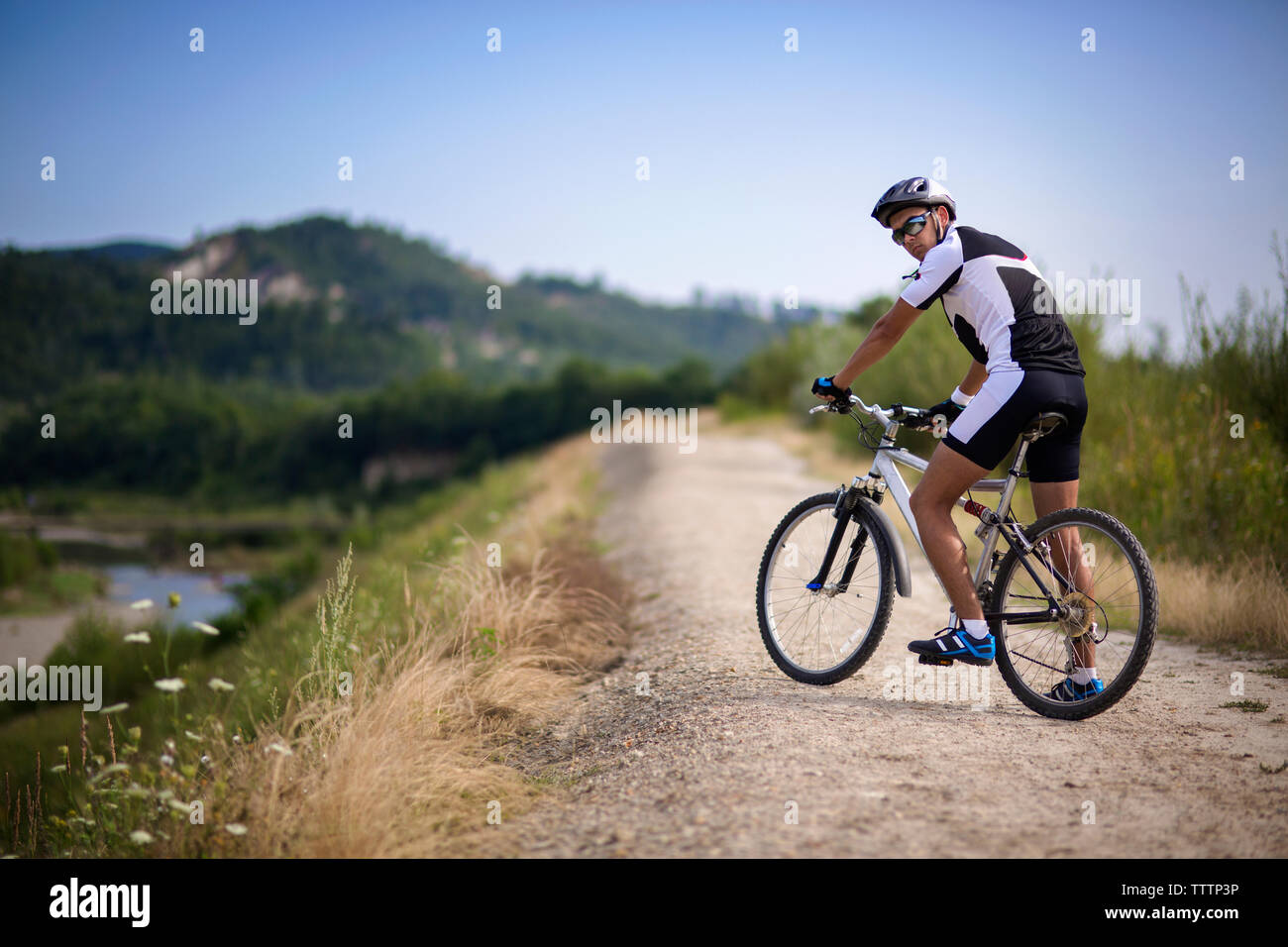 Man sitting on grass bicycle hi-res stock photography and images - Alamy