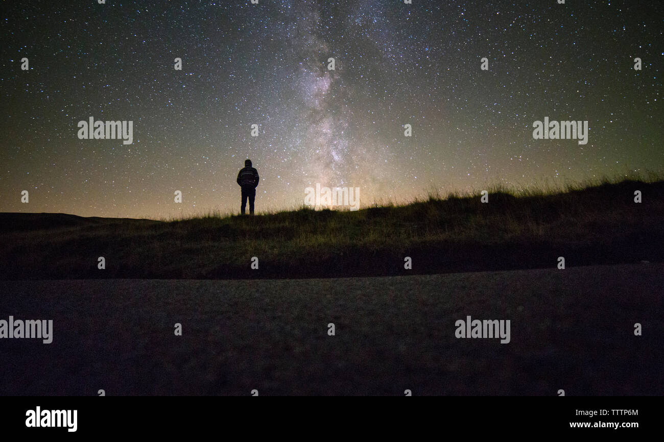 Man standing against star field at night Stock Photo - Alamy