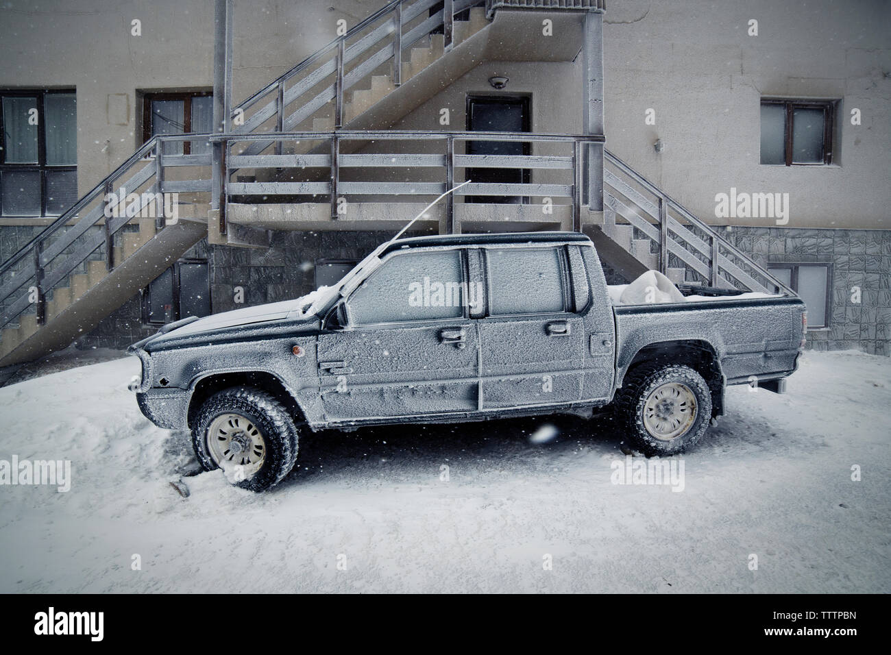 Pick-up truck covered with snow by staircase Stock Photo - Alamy