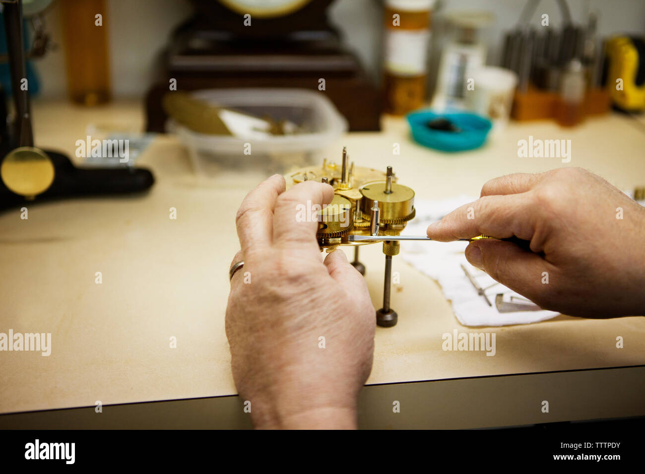 Manual worker making clock at workshop Stock Photo - Alamy