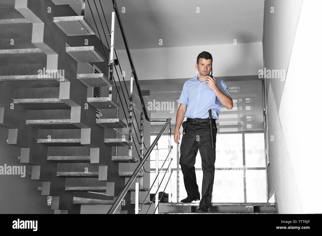 Security man walking on stairs Stock Photo - Alamy