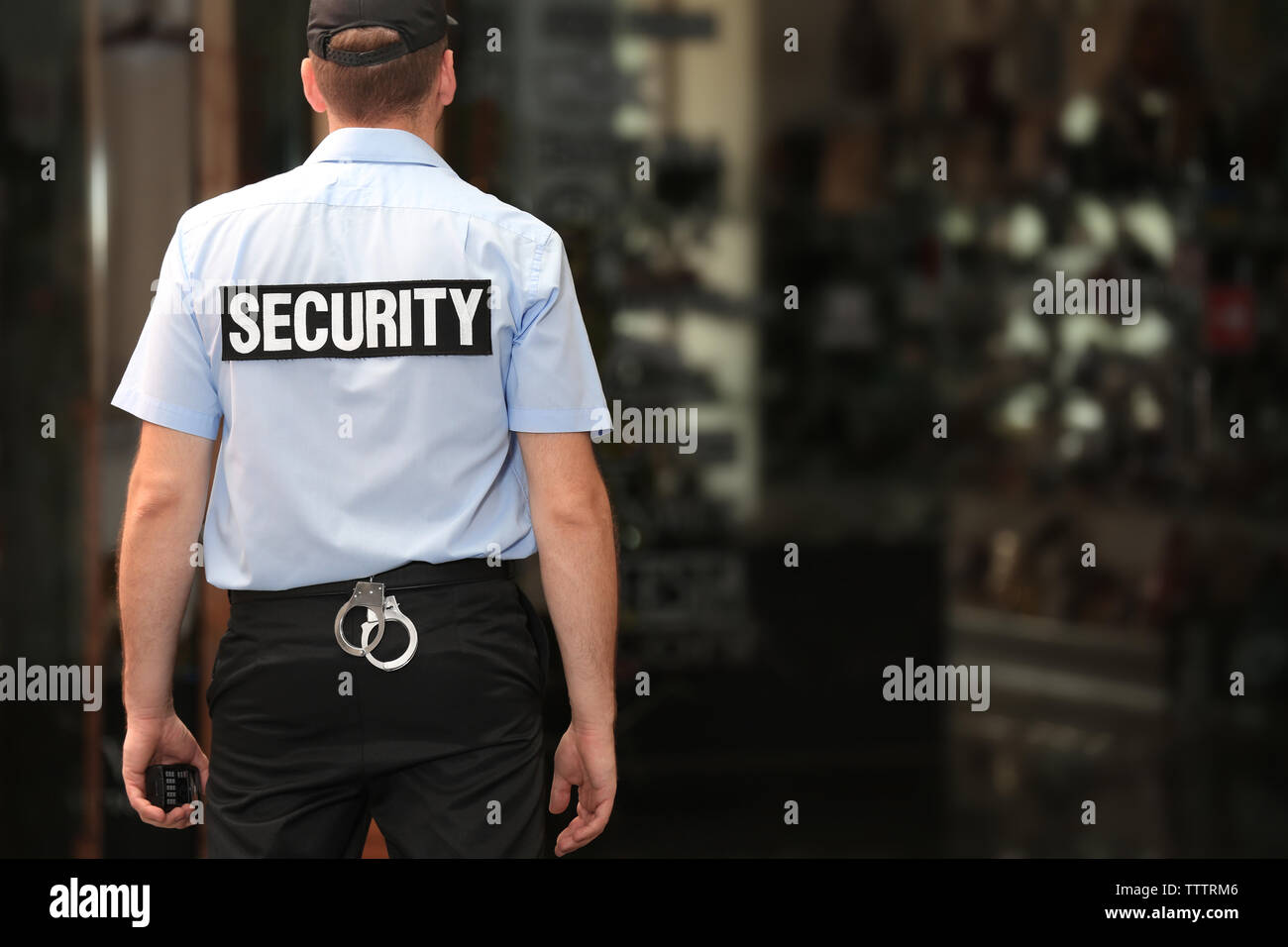 Security man standing indoors Stock Photo - Alamy