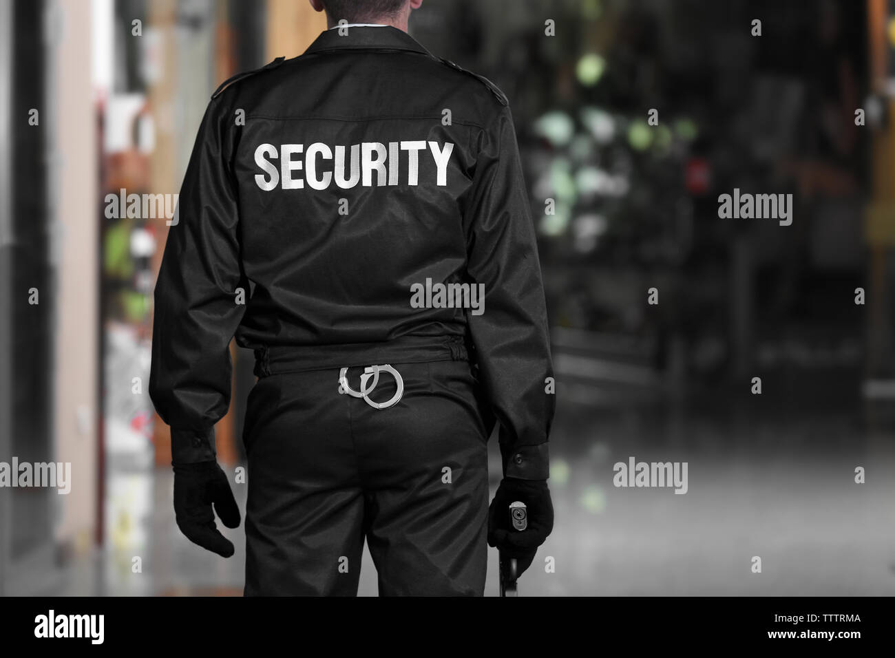 Security man standing indoors Stock Photo - Alamy