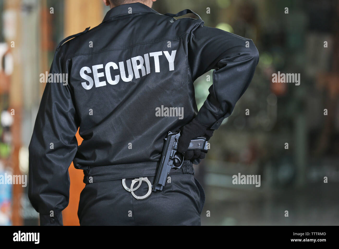 Security man standing indoors Stock Photo - Alamy