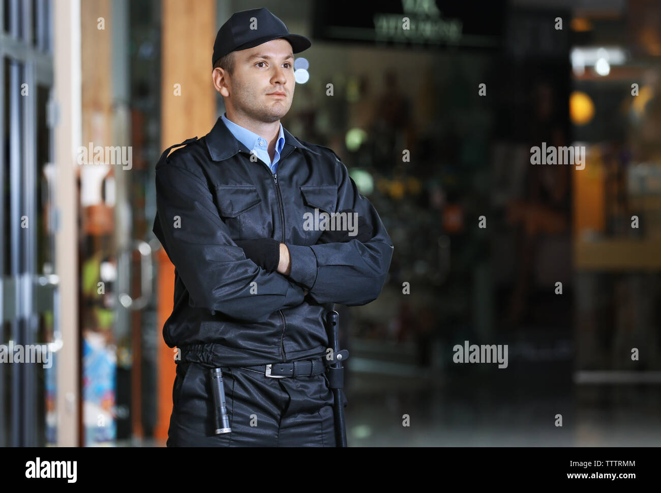 Security man standing indoors Stock Photo - Alamy