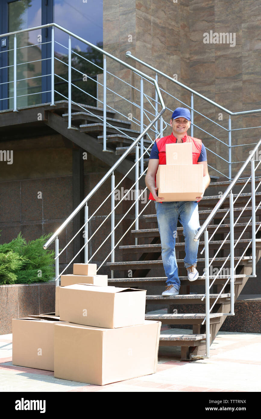 Man carrying boxes stairs hi-res stock photography and images - Alamy