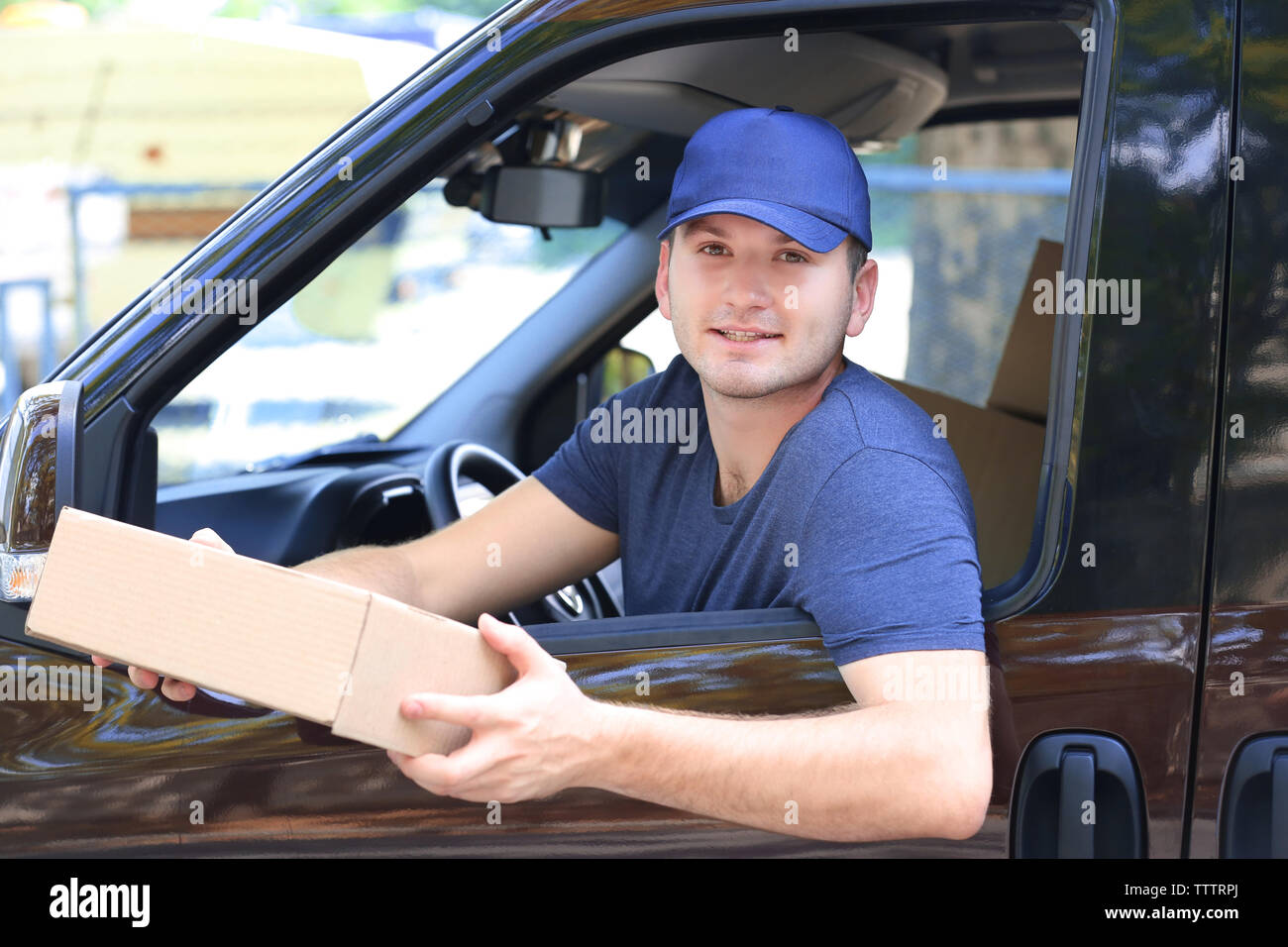 Male worker giving package goods hi-res stock photography and images ...