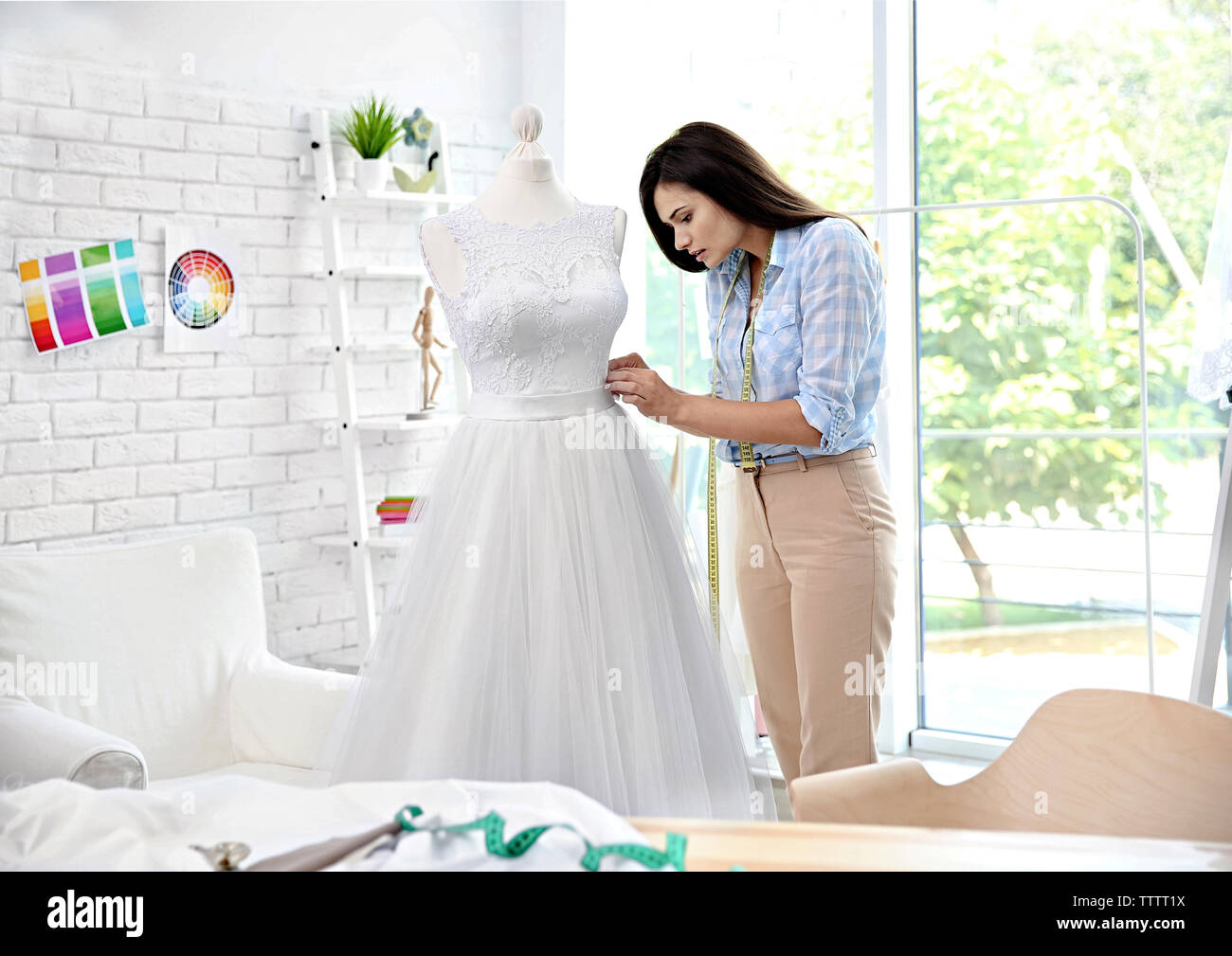 Pretty young woman making wedding dress Stock Photo - Alamy