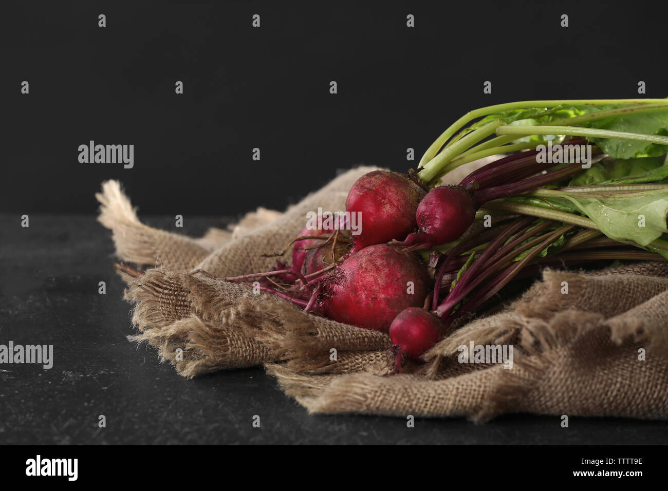 Bunch of fresh beets on bagging and black background Stock Photo - Alamy