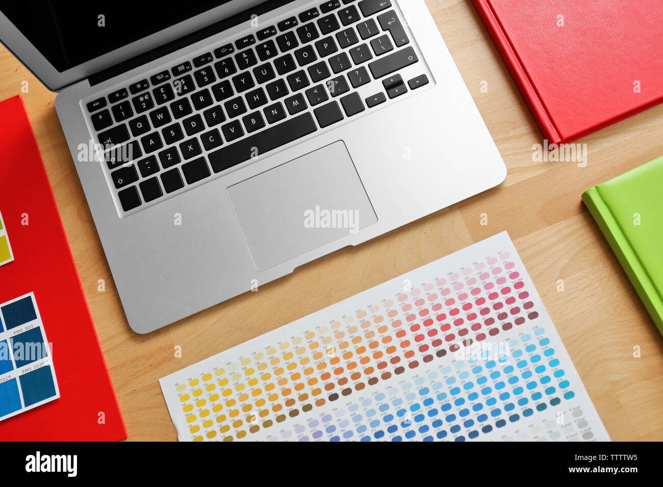 Designer workplace with colour palette and laptop Stock Photo - Alamy