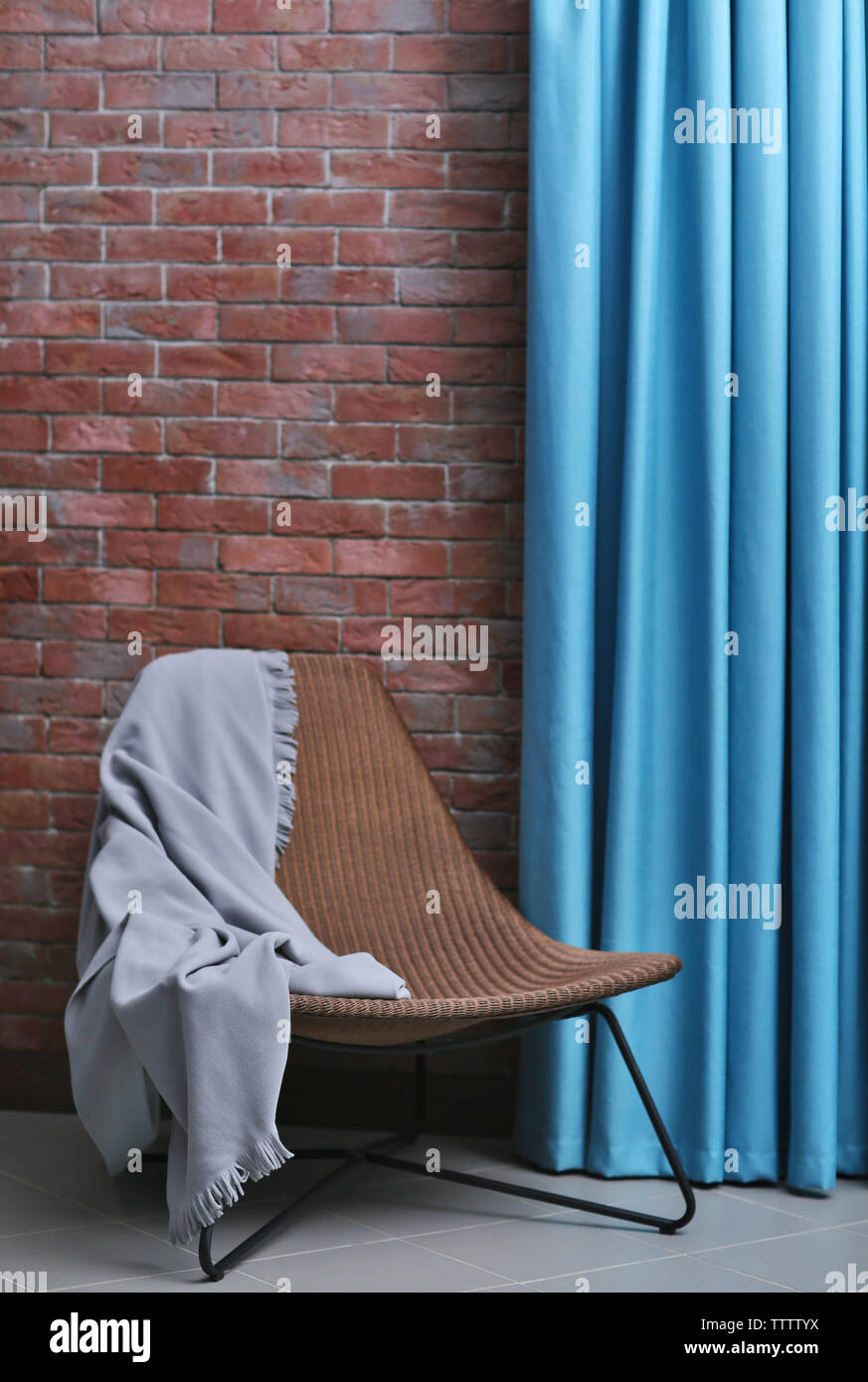 Chair in room with blue curtains Stock Photo - Alamy