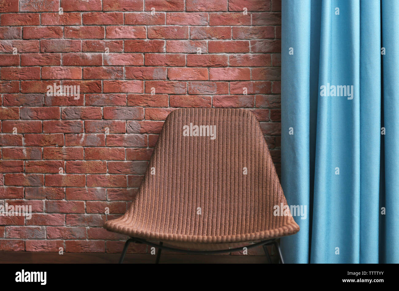Chair in room with blue curtains Stock Photo - Alamy