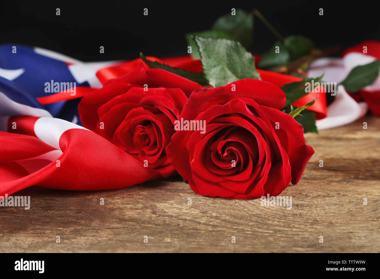 Red roses on American flag, closeup Stock Photo - Alamy