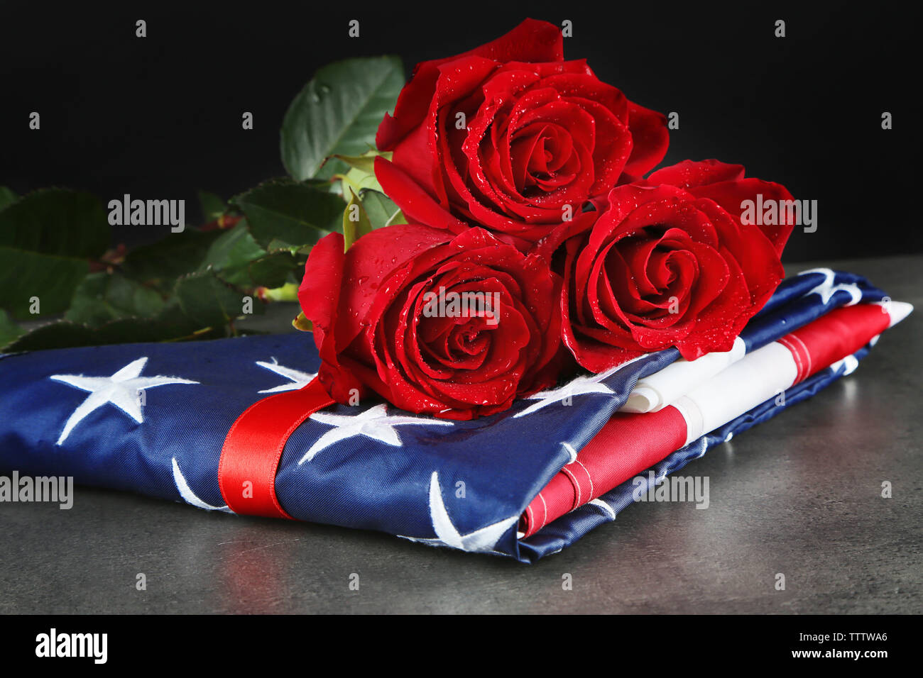 Red roses on American flag, closeup Stock Photo - Alamy