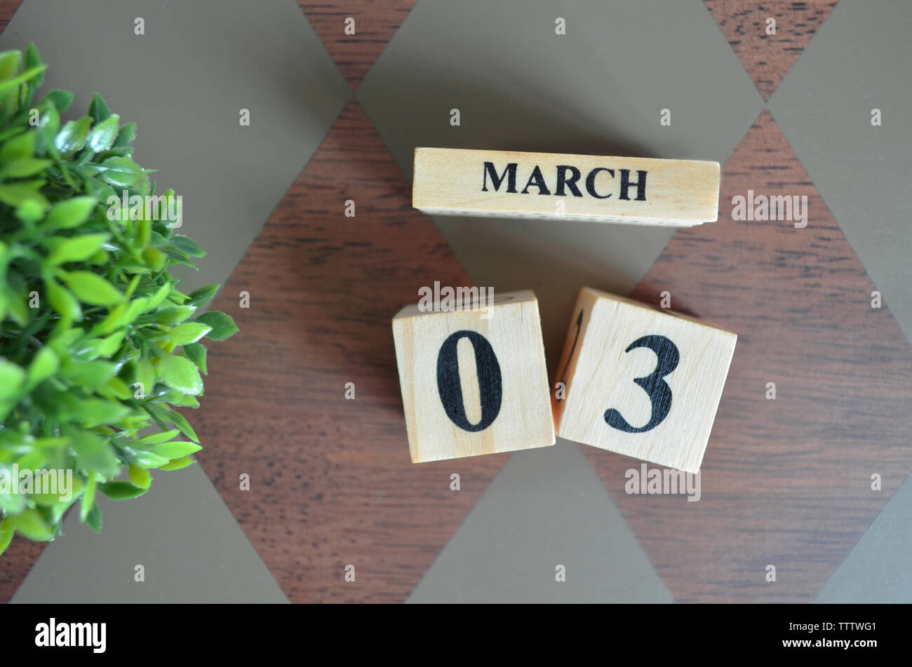 Date of March with leaf on diamond pattern table for background Stock ...