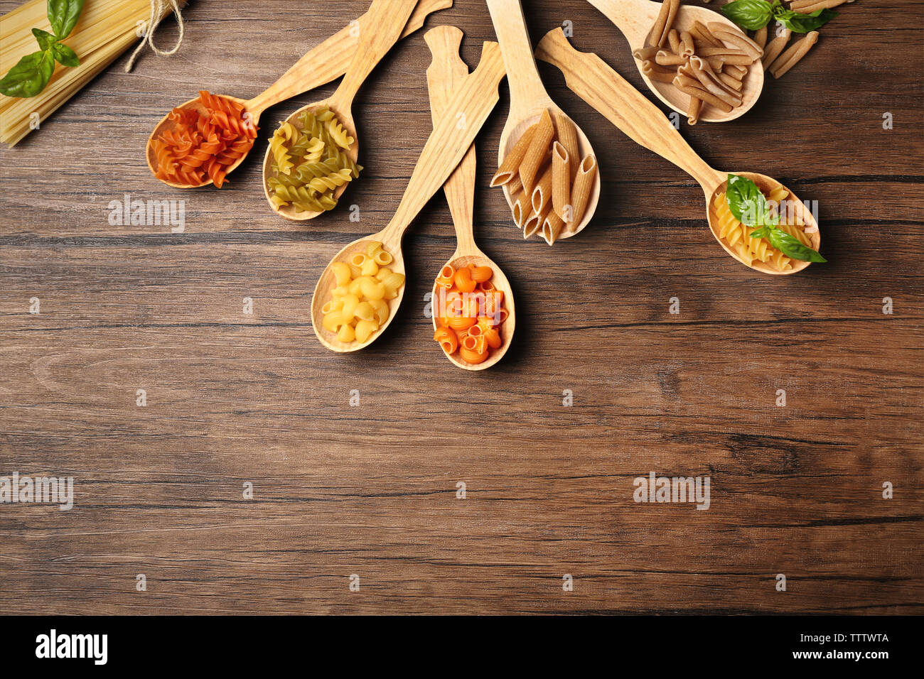 Different dry pasta on measuring spoons Stock Photo - Alamy