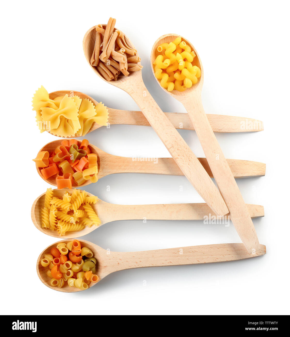 Wooden spoons with pasta, isolated on white Stock Photo - Alamy