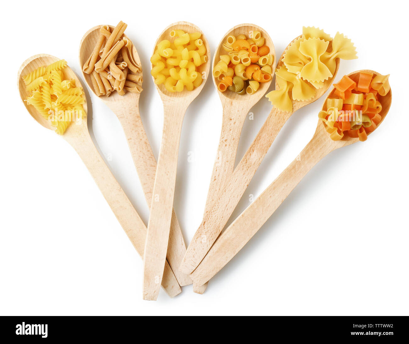Wooden spoons with pasta, isolated on white Stock Photo - Alamy
