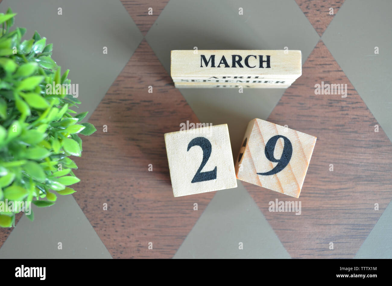 Date of March with leaf on diamond pattern table for background Stock ...