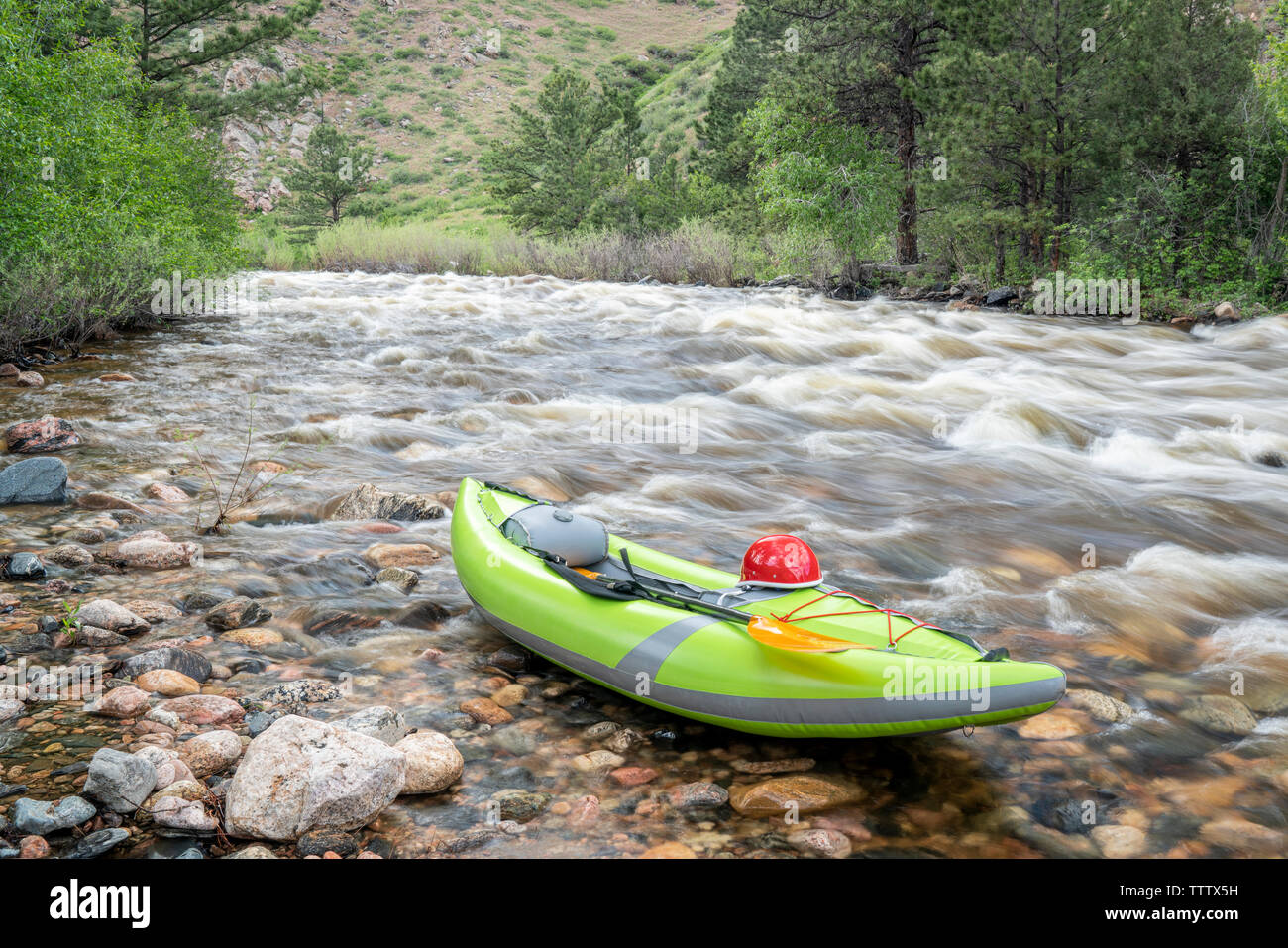inflatable whitewater kayak on a shore of a mountain river - Poudre ...
