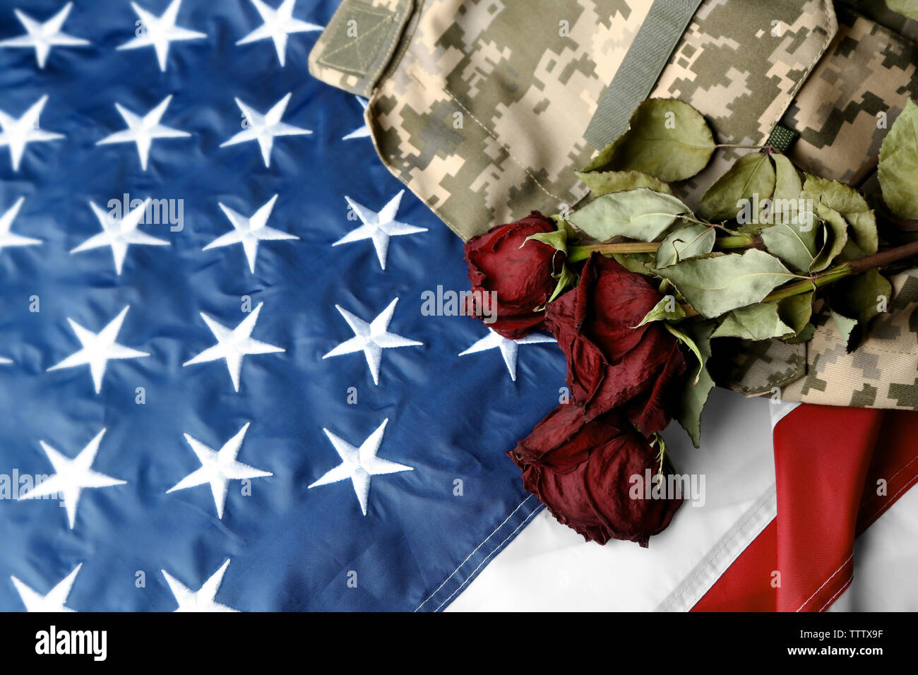 Dried roses and military uniform on American national flag. Veterans ...