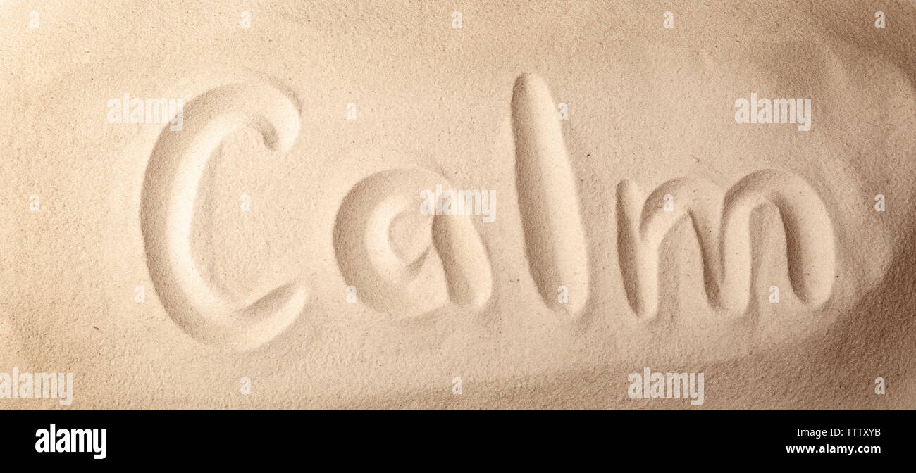 Word CALM written on sand Stock Photo - Alamy