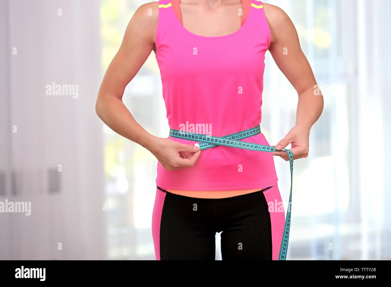 Muscular female measuring her waist hi-res stock photography and images ...