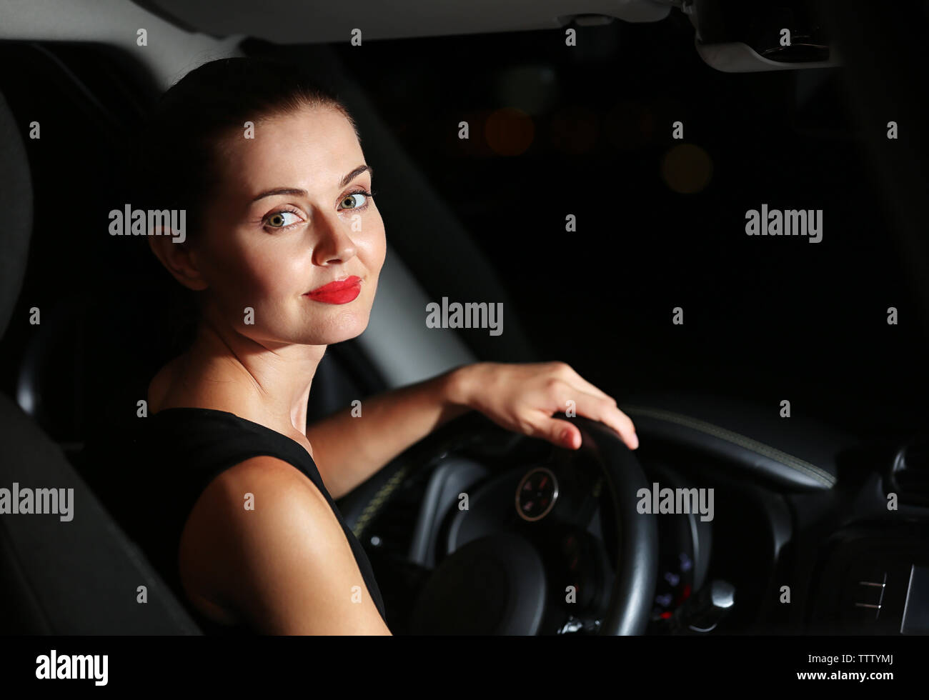 Beautiful young woman driving car Stock Photo - Alamy
