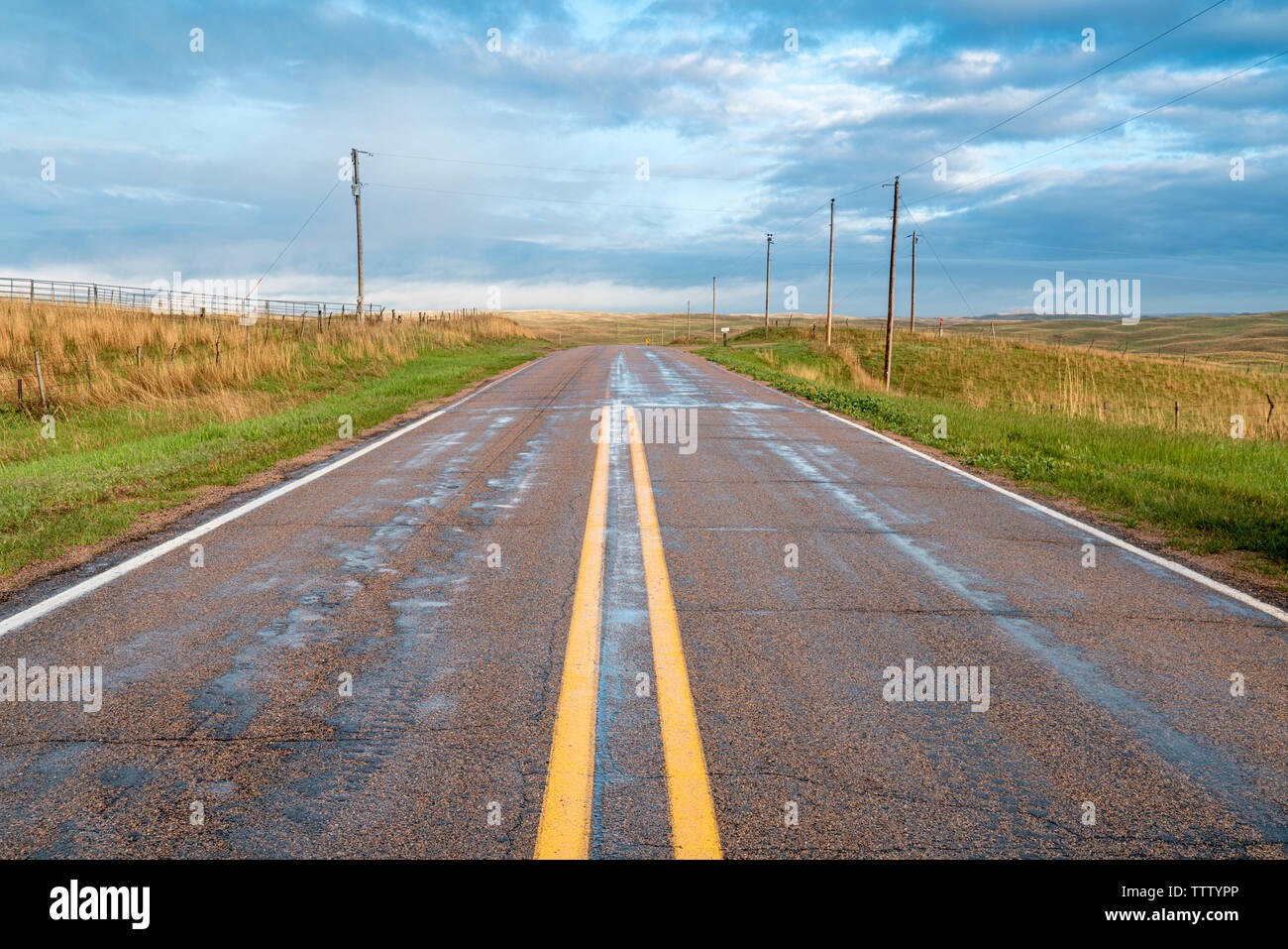 wet rural highway in Nebraska Sandhills, morning spring scenery Stock ...
