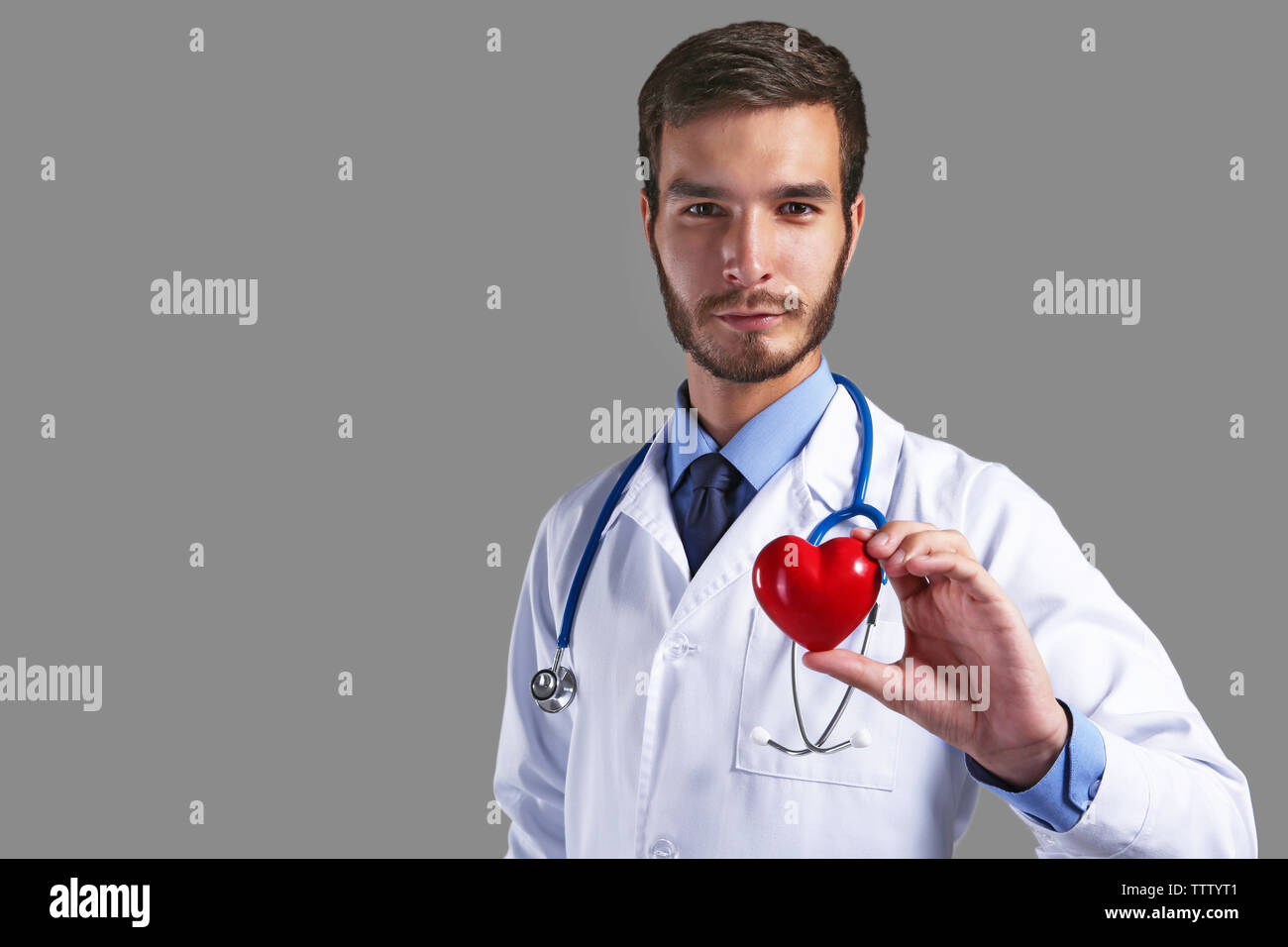 Handsome doctor holding heart hi-res stock photography and images - Alamy