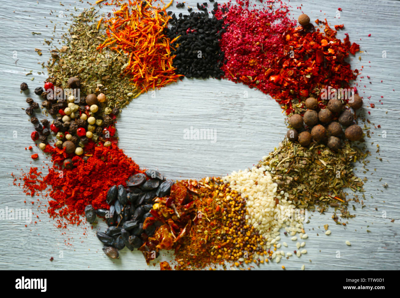 Mix of different spices in circle shape on wooden background Stock ...