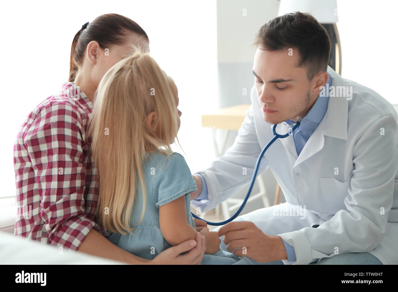 Male pediatrician doctor examining small girl Stock Photo - Alamy