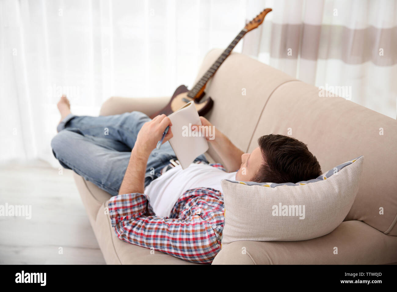 Young man lying rock hi-res stock photography and images - Alamy