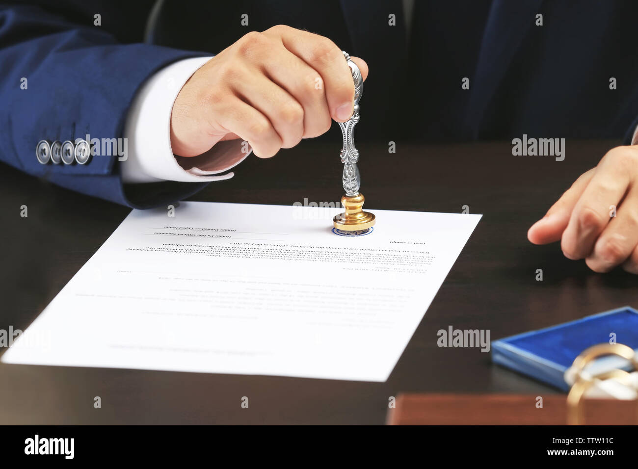 Notary public in office stamping document Stock Photo - Alamy
