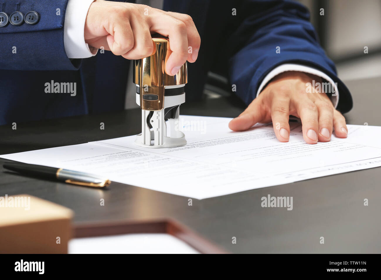 Notary public in office stamping document Stock Photo - Alamy