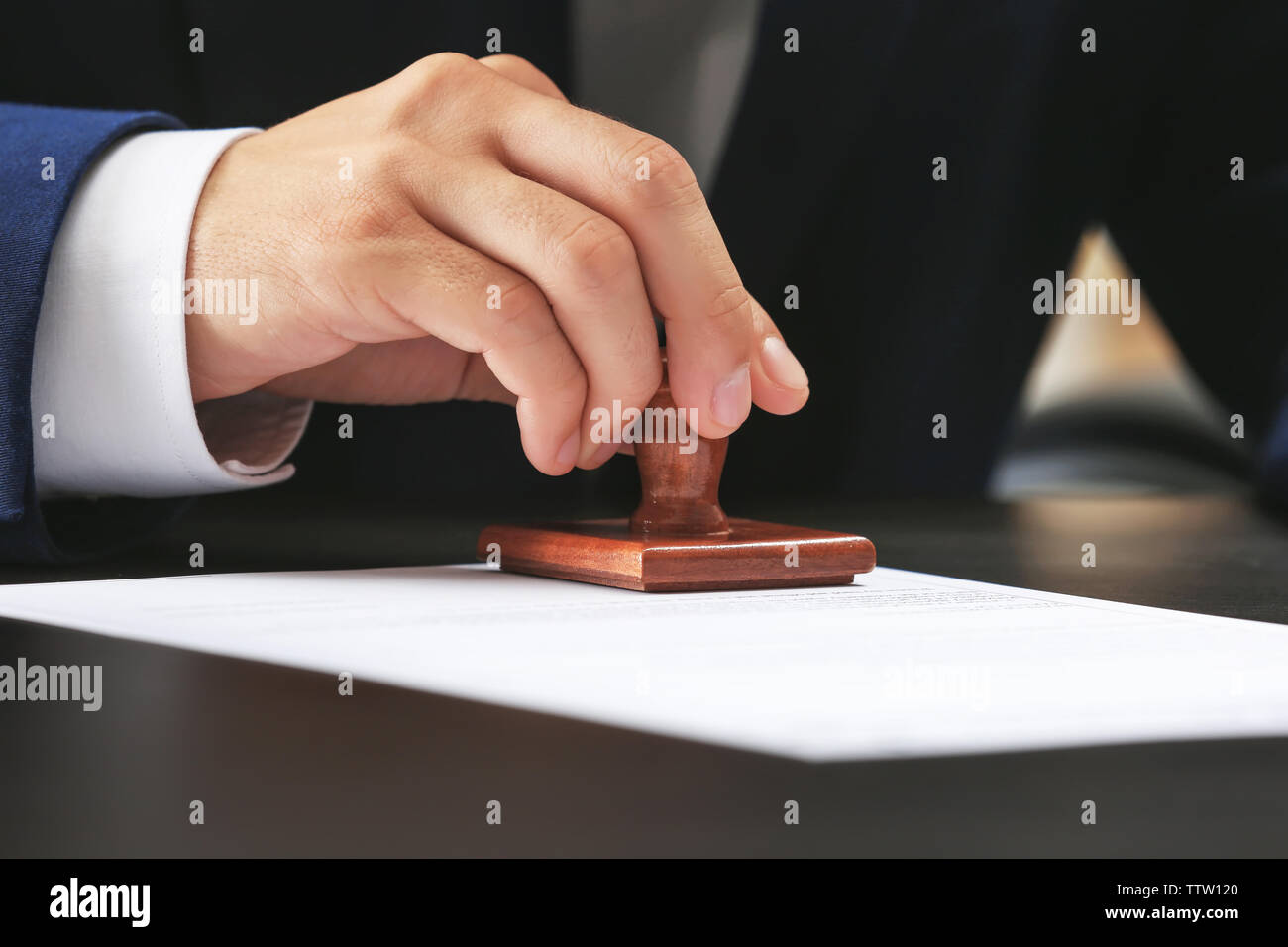 Notary public in office stamping document Stock Photo - Alamy