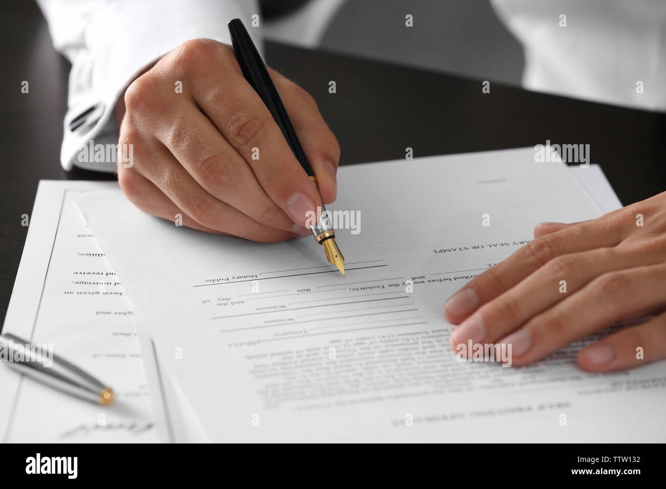 Notary public in office signing document Stock Photo - Alamy
