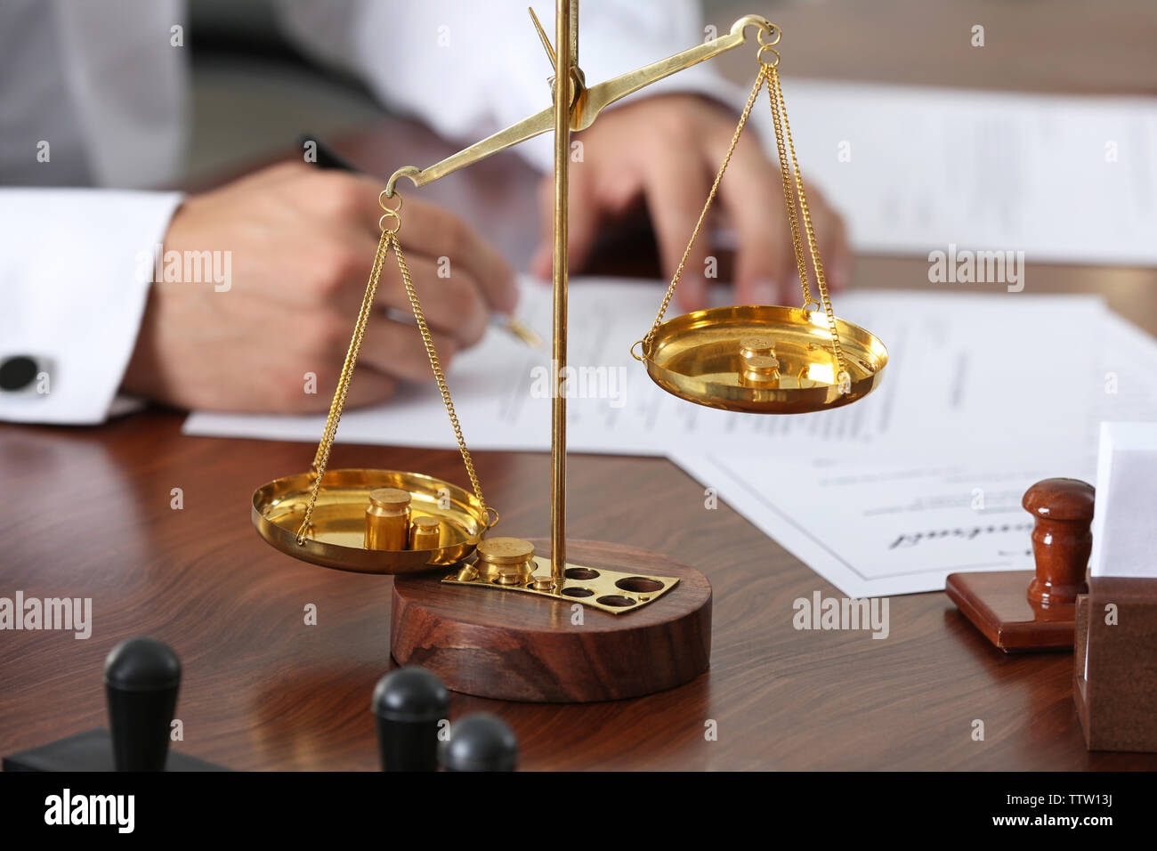 Scales on notary public table, concept Stock Photo - Alamy