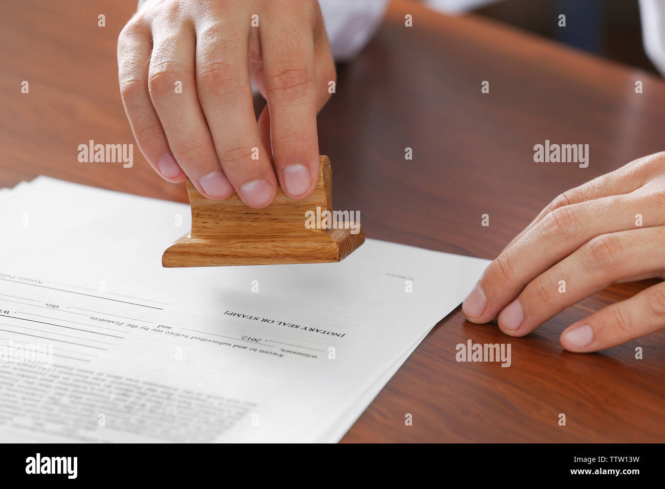 Notary public in office stamping document Stock Photo - Alamy