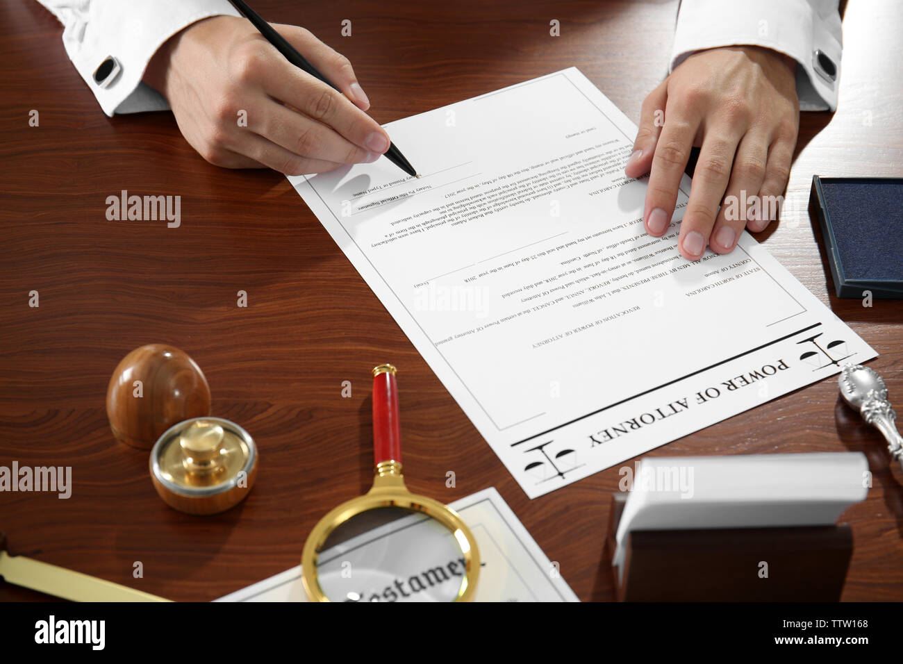 Notary public signing document in office Stock Photo - Alamy