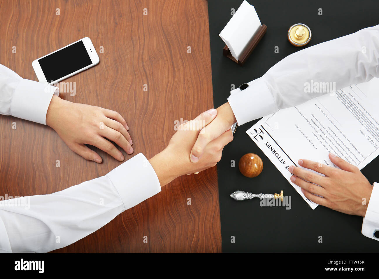Man and notary public shaking hands in office Stock Photo - Alamy