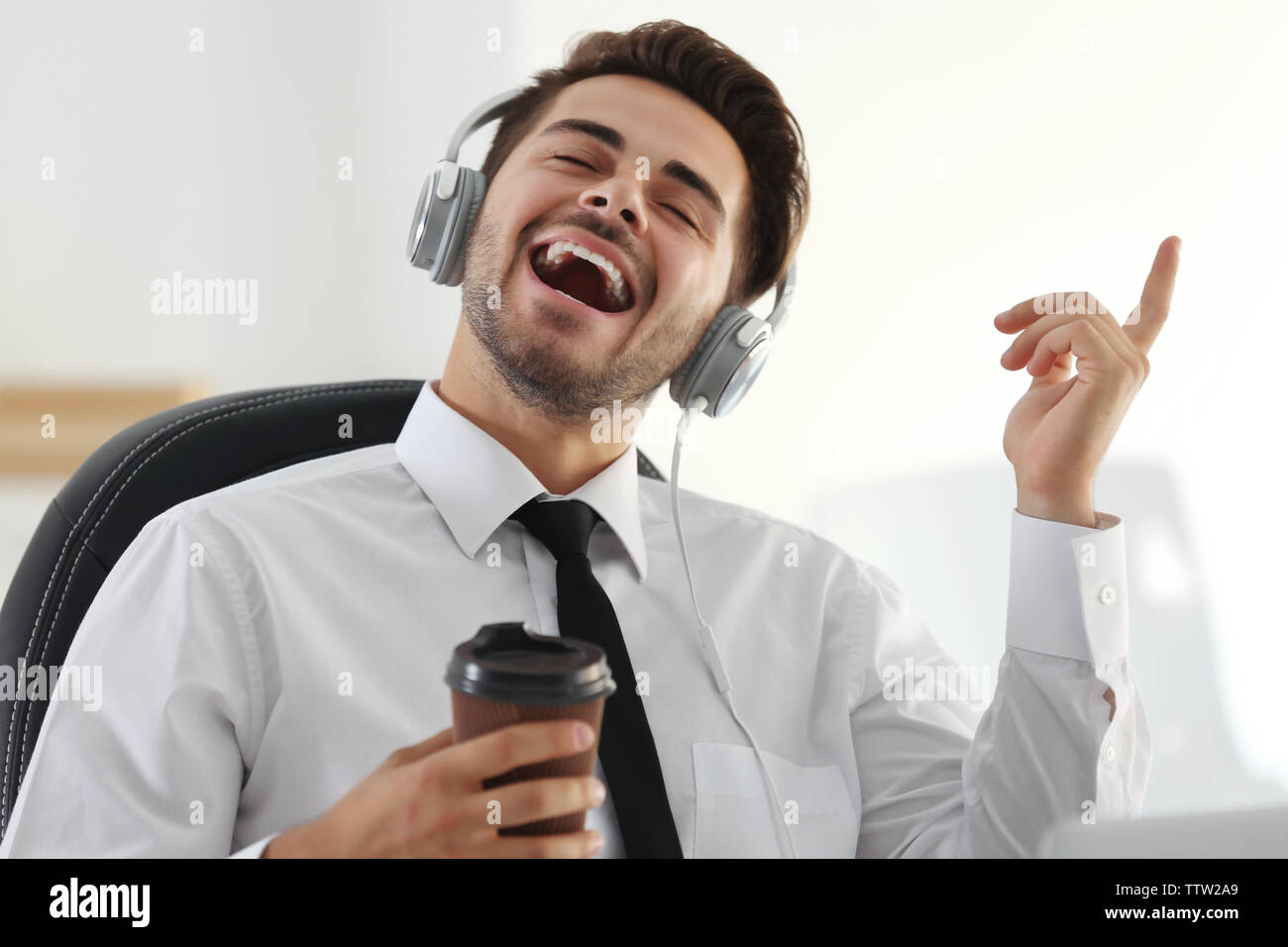 Businessman listening singing music working hi-res stock photography ...