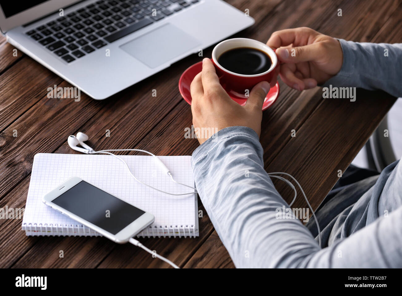 Man having coffee break at workplace Stock Photo - Alamy