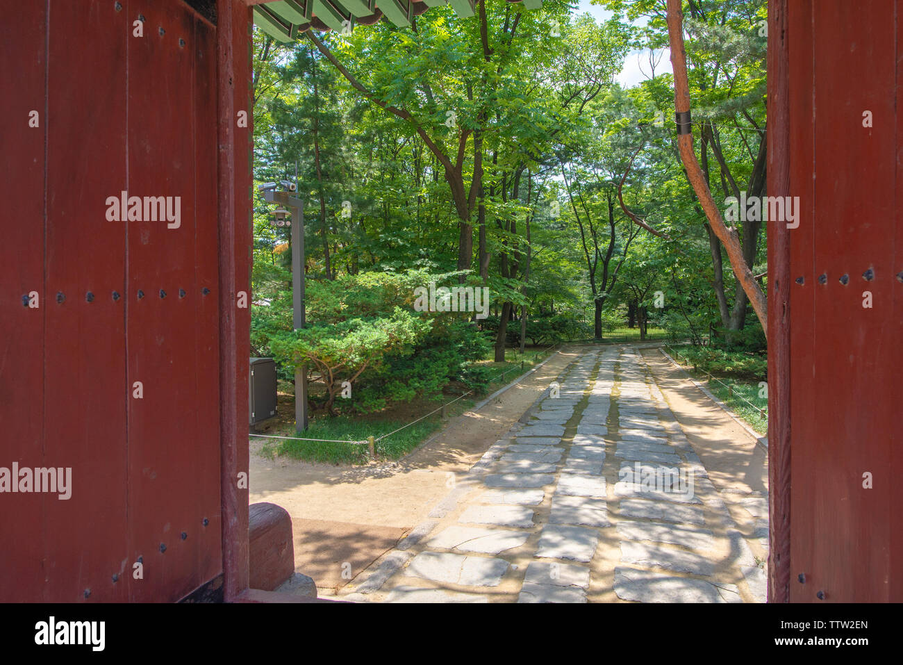 A gate, painted in red, opens to a sacred path, Jongmyo Confucian Royal ...