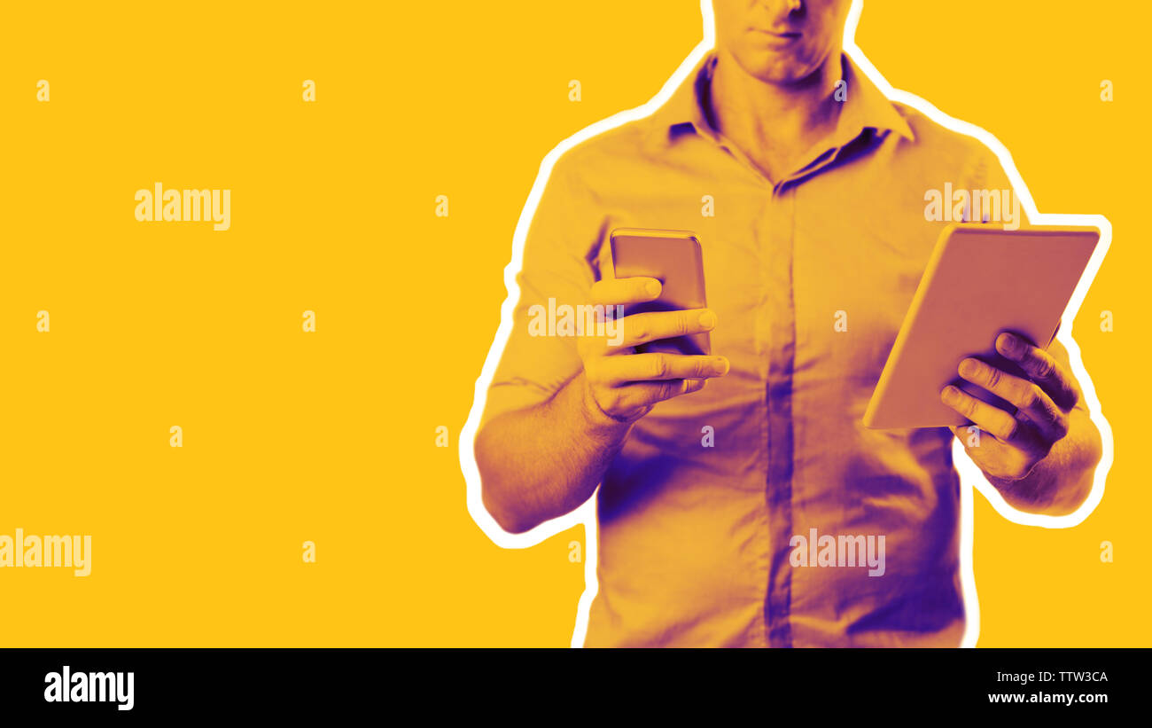 Man dressed casually in collared shirt using a tablet and phone ...